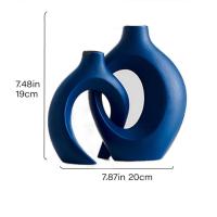 China Embrace Hollow Ceramic Vase for Modern Home Decor for sale