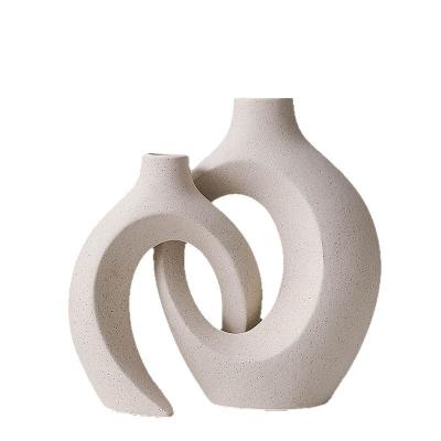 China Embrace Hollow Ceramic Vase for Modern Home Decor for sale