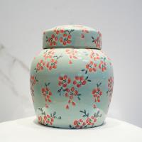 China Glossy Green Ceramic Urn with Floral Berry Motif for sale