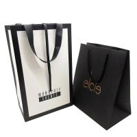 China Custom 300gsm Kraft Paper Gift Bag Full Color Printing with Handle for Clothing Packaging for sale