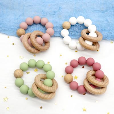 China BPA Free Eco-Friendly Baby Teether Healthy Wooden Silicone Bead Teethers Personalized Custom Teething Bracelet Rattle Ring Wholesale for sale