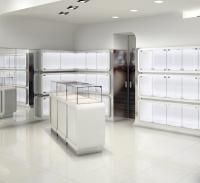 China Minimalist Microcement Cream Style LED Durable High End Custom Curved Jewelry Display Cases Stainless Steel Legs for Retail for sale