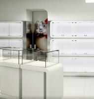 China Minimalist Microcement Cream Style LED Durable High End Custom Curved Jewelry Display Cases Stainless Steel Legs for Retail for sale