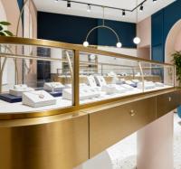 China Straight Modular Jewelry Display Counter | Pink Navy Blue Gold Metal Edging | Arc Middle Island Counter Built-in Retail Store for sale