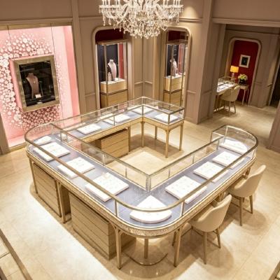 China Luxury Champagne Gold LED Eco-Friendly Jewelry Store Interior Design Complete Turnkey Fixture Package U-Shaped Central Showcase for sale
