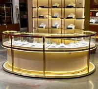 China Luxury Champagne Gold Curved Jewelry Display Counter, Modern Irregular Showcase with LED Lighting & Glass Top for sale