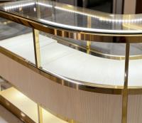 China Custom Curved Jewelry Display Cabinet Set | Cream Gold Finish | Middle Island Counter + Wall Mounted Showcase | LED Lit Durable for sale
