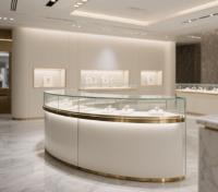 China Curved Island Customizable Jewelry Display Counter | Cream Body with Gold Trim | Glass Showcase LED Lights for Retail Store Mall for sale
