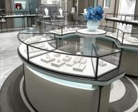 China Custom Curved Jewelry Display Stand, Gold Stainless Steel Glass Counter for Luxury Jewelry Store for sale