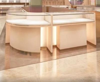 China Luxury Warm Apricot Curved Jewelry Display Cases High End Custom Glass Showcases with LED Lighted Base for Showroom for sale