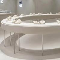 China Minimalist Curved LED Jewelry Island Display Case High End Custom Jewelry Showcase Open Top Stainless Steel Legs Store for sale