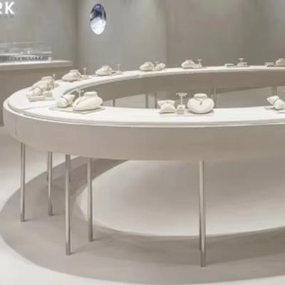 China Minimalist Curved LED Jewelry Island Display Case High End Custom Jewelry Showcase Open Top Stainless Steel Legs Store for sale