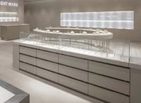 China Minimalist Curved LED Jewelry Island Display Case High End Custom Jewelry Showcase Open Top Stainless Steel Legs Store for sale