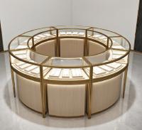 China Circular Modular Modern Luxury Jewelry Island Counter | Brushed Gold Wood Grain | LED Tempered Glass Showcase for sale