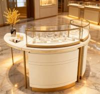China Luxury Curved Reception Jewelry Display Counter | Beige Body Brushed Gold Frame Side Table | Curved Acrylic/Glass Showroom for sale