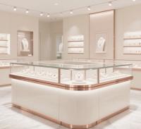 China Luxury Island Jewelry Display Counter Rounded Corner Cream Rose Gold Glass Showcase With LED for Retail Shop for sale