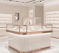 China Luxury Island Jewelry Display Counter Rounded Corner Cream Rose Gold Glass Showcase With LED for Retail Shop for sale