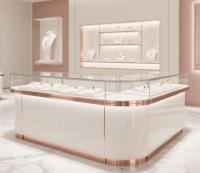 China Luxury Island Jewelry Display Counter Rounded Corner Cream Rose Gold Glass Showcase With LED for Retail Shop for sale