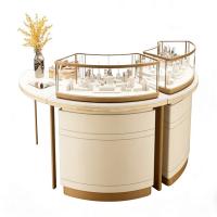 China Luxury Curved Jewelry Display Counter | Beige Body Brushed Gold Metal Frame Side Table | Curved Glass Showcase Built-in for sale