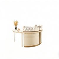 China Luxury Curved Jewelry Display Counter | Beige Body Brushed Gold Metal Frame Side Table | Curved Glass Showcase Built-in for sale