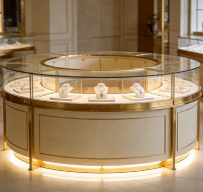 China Luxury Curved Jewelry Display Cabinet LED | Cream Color Solid Wood Gold Metal Frame | Middle Island Counter High-End Jewelry for sale