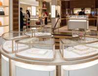 China Curved Single Jewelry Display Showcase LED | Cream Color Gold Metal Edging | Rounded Corner High-End Jewelry Boutique for Mall for sale