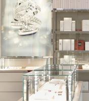 China Luxury Modern Curved Jewelry Display Island with Gold Metal Frame LED Lighting Quilted White Base for Mall Use for sale