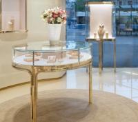 China Modern Freestanding Jewelry Display Counter Marble Top Curved Glass Showcase Decorative Gold Legs LED Lighting Retail Showroom for sale