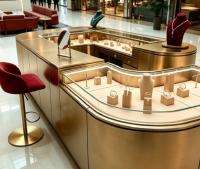 China Luxury Champagne Gold Curved Jewelry Island Service Counter Display Cabinet, High-End Glass Showcase for Fine Jewelry Retail for sale