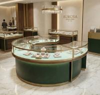 China Luxury Emerald Green Gold Frame Round Island Jewelry Display Cabinet, Premium Tempered Glass Showcase for Luxury Jewelry Retail for sale