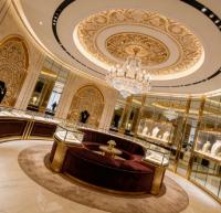 China Luxury Curved Glass Island Jewelry Display Counter Burgundy Velvet VIP Sofa Gold Plated Frame Showcase High-End Jewelry Showroom for sale
