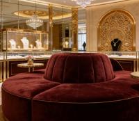 China Luxury Curved Glass Island Jewelry Display Counter Burgundy Velvet VIP Sofa Gold Plated Frame Showcase High-End Jewelry Showroom for sale