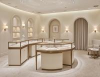China Elegant Round LED Lit Metal Jewelry Display Case Cream Base Gold Frame Glass Top for Luxury Mall Retail for sale