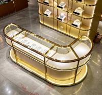 China Luxury Gold Frame Curved Glass Jewelry Island Display Case, LED Jewelry Showcase for sale