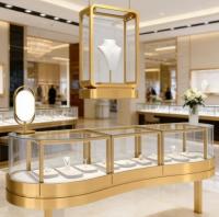 China Luxury Modern Curved Glass Jewelry Display Case with Gold Trim Premium Boutique Showcase for Fine Jewelry in Shopping Malls for sale
