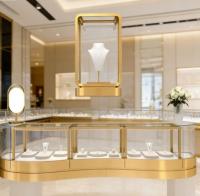 China Luxury Modern Curved Glass Jewelry Display Case with Gold Trim Premium Boutique Showcase for Fine Jewelry in Shopping Malls for sale