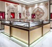 China Custom Luxury Jewelry Store New Chinese Red & Gold Glass Island Display Cabinet for sale