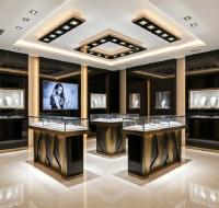 China Custom Luxury Geometric Jewelry Display Counter Premium Black Gold Stainless Steel Glass Showcase High-End Jewelry Boutique Mall for sale