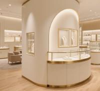 China Luxury Curved Island Jewelry Display Counter for Mall Use | Cream Body Gold Trim | Glass Showcase LED Lighting | Customizable for sale