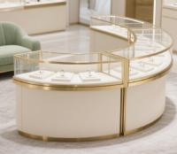 China Curved Arc High Quality Jewelry Display Counter | Cream Body Gold Trim | Glass Showcase LED Lights Retail Store Shopping Mall for sale