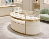 China Curved Arc High Quality Jewelry Display Counter | Cream Body Gold Trim | Glass Showcase LED Lights Retail Store Shopping Mall for sale