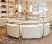 China Curved Single Jewelry Display Showcase LED | Cream Color Gold Metal Edging | Rounded Corner High-End Jewelry Boutique for Mall for sale