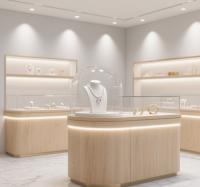China Rounded Corner Island Jewelry Display Counter | Light Wood Body Gold Trim Glass Showcase | Built-in LED Lights High Showroom for sale