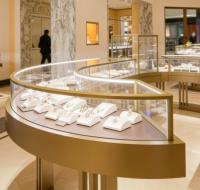 China Luxury S-Shaped Curved Jewelry Display Cabinet | Brushed Gold Metal Frame Marble Accents | Glass Showcase Mall Showrooms for sale
