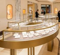 China Luxury S-Shaped Curved Jewelry Display Cabinet | Brushed Gold Metal Frame Marble Accents | Glass Showcase Mall Showrooms for sale