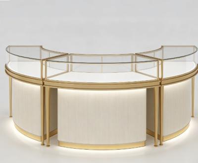 China Curved Jewelry Display Counter Reception Desk | Cream Color Gold Metal Edging | Semi-Circular Middle Island Counter Set Showroom for sale