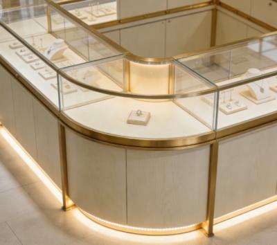 China Luxury Jewelry Display Cabinet for Mall Retail Store | Cream Solid Wood Gold Metal Frame | Built-in LED Lights Circular Design for sale