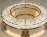 China Luxury Jewelry Display Cabinet for Mall Retail Store | Cream Solid Wood Gold Metal Frame | Built-in LED Lights Circular Design for sale