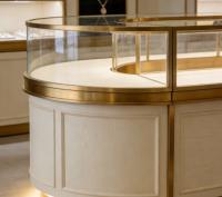 China Luxury Jewelry Display Cabinet for Mall Retail Store | Cream Solid Wood Gold Metal Frame | Built-in LED Lights Circular Design for sale