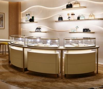 China Curved Single Jewelry Display Showcase LED | Cream Color Gold Metal Edging | Rounded Corner High-End Jewelry Boutique for Mall for sale